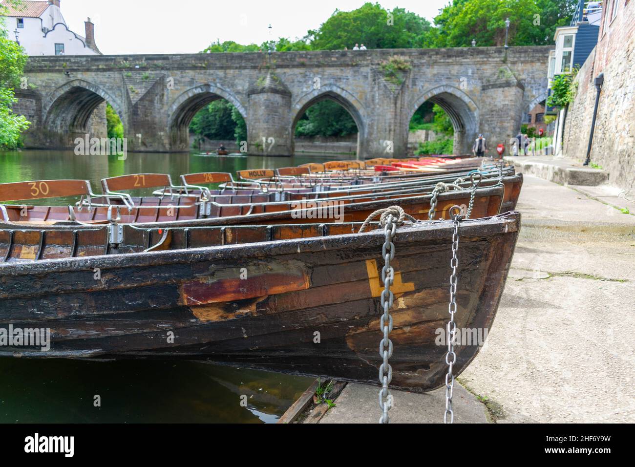 Rowing boats lined up on the Wear river in the city centre of Durham ...