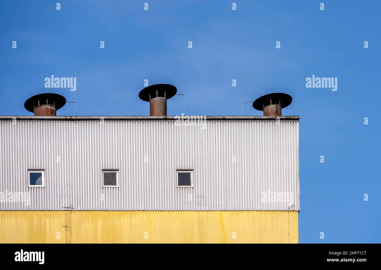 yellow industrial building, three chimneys, three windows, harbor ...