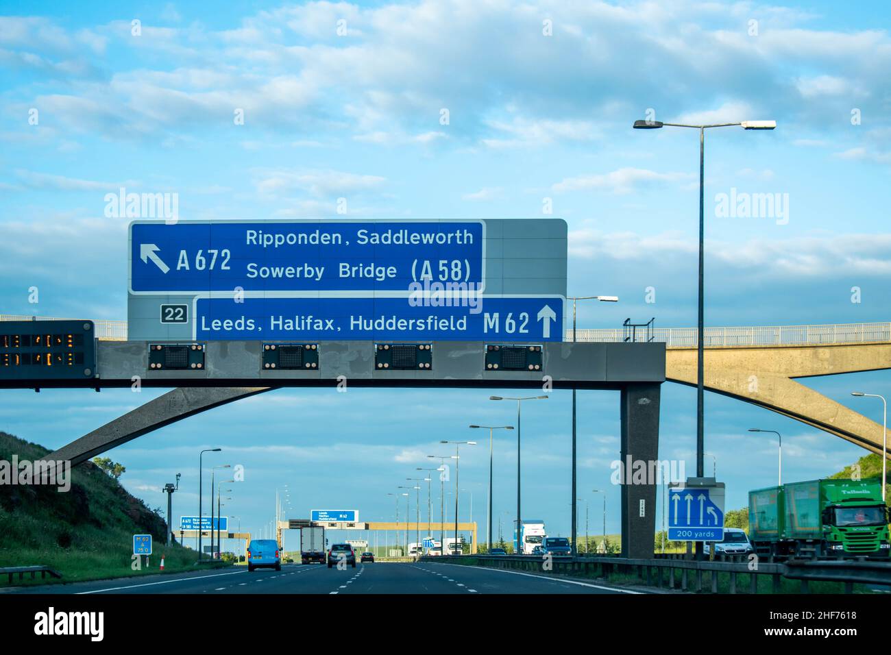 Leeds, UK - 19th June 2019: A Blue British motorway sign above the ...