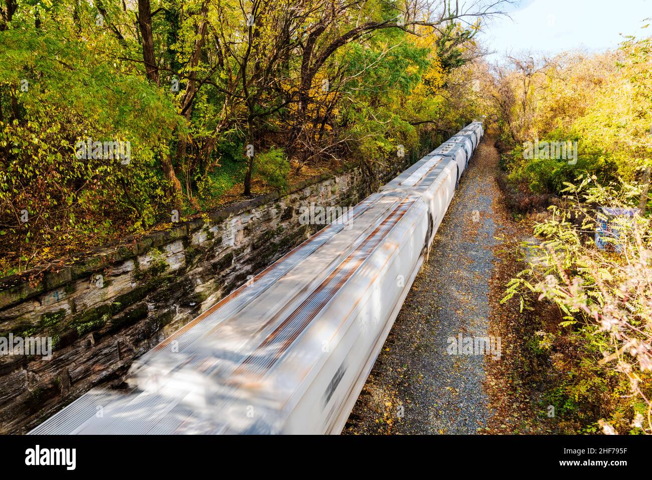 Blur - pan - action overhead view of freight train moving down railroad ...