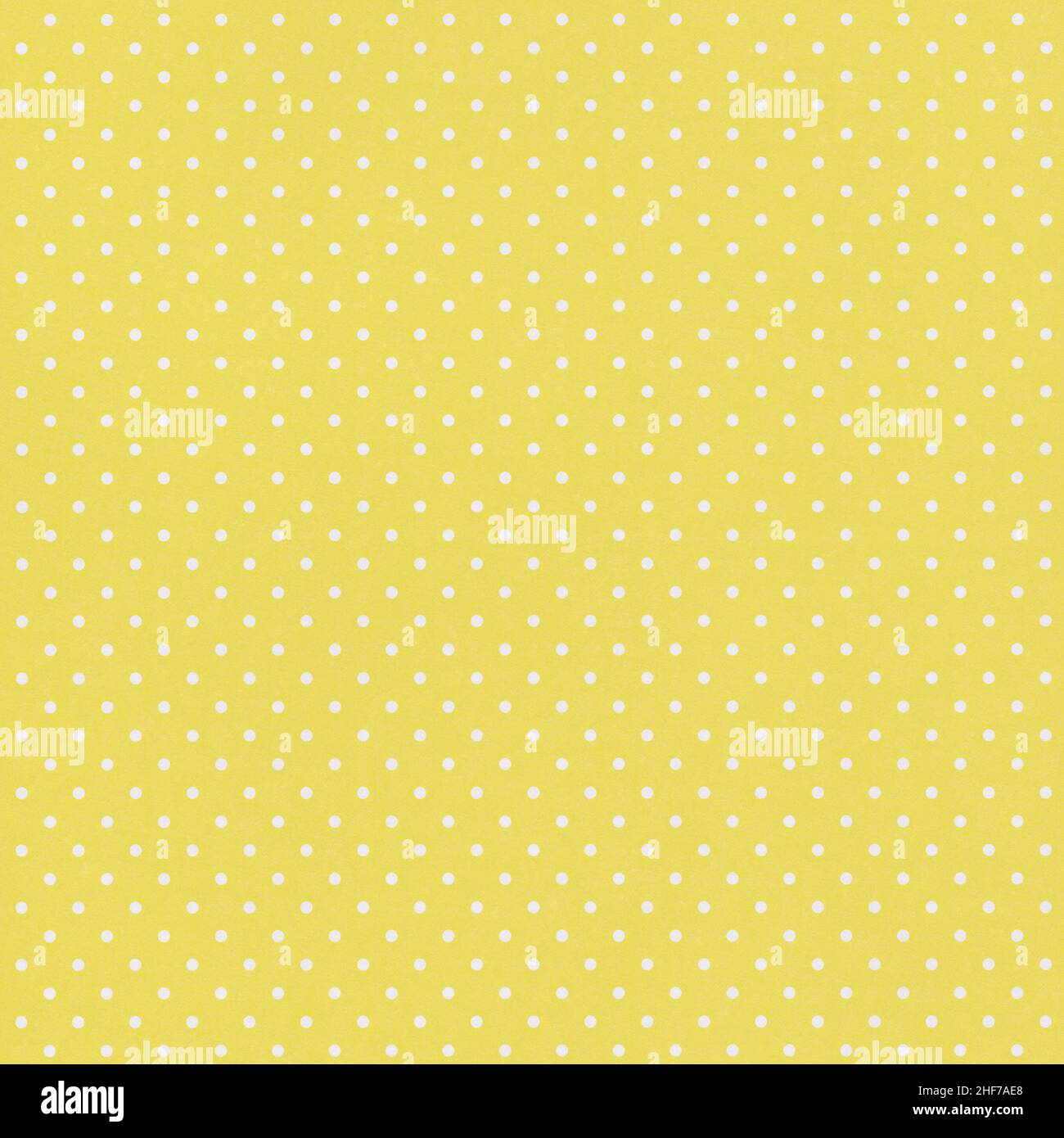 Yellow paper background with polka dot pattern Stock Photo - Alamy
