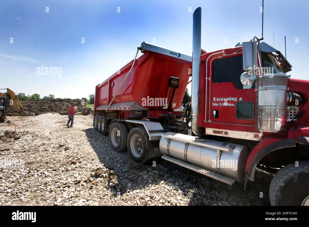 Red dump truck on excavation site Stock Photo - Alamy