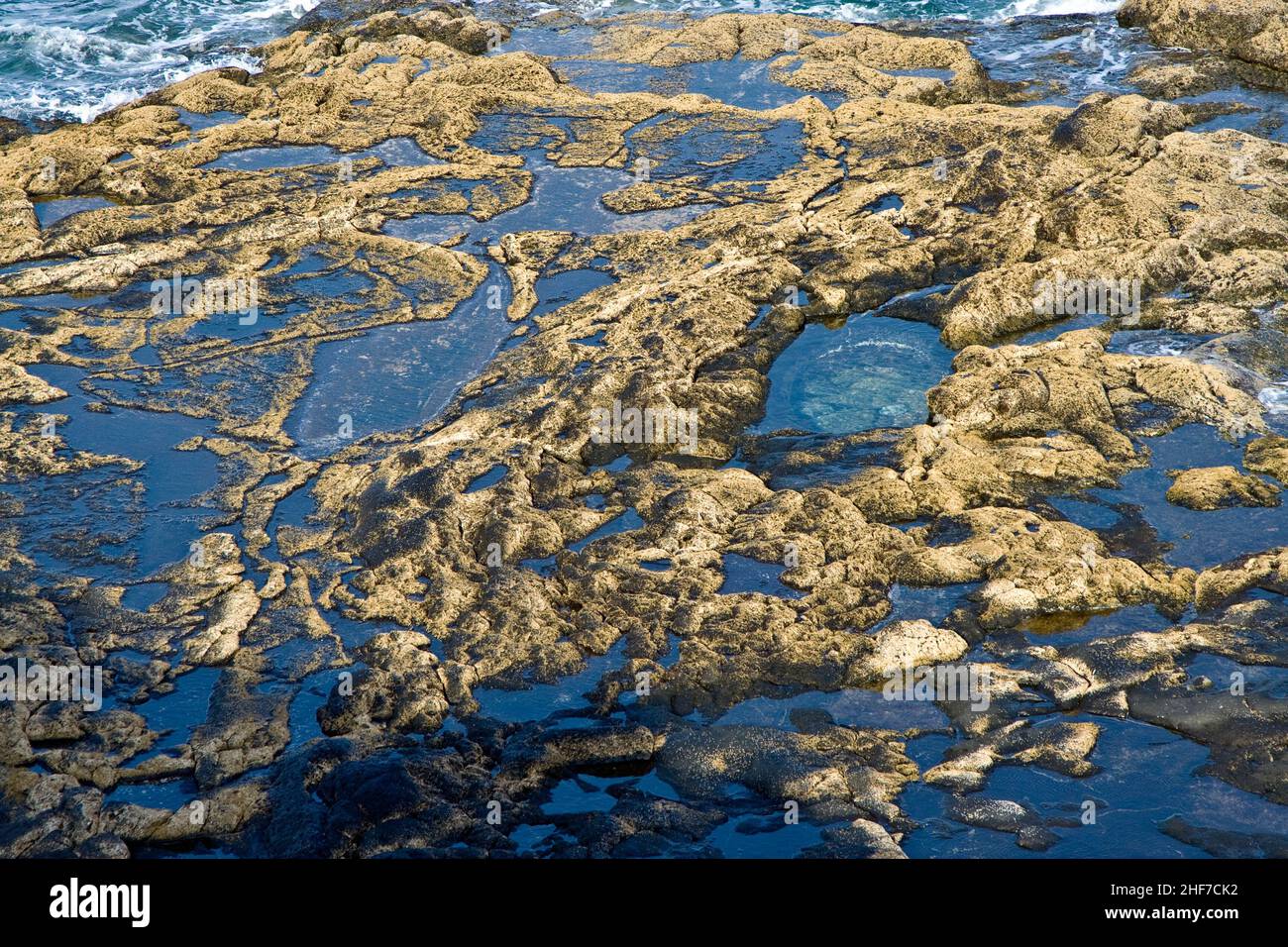 beautiful stone structure at the coast line giving a natural pool with ...