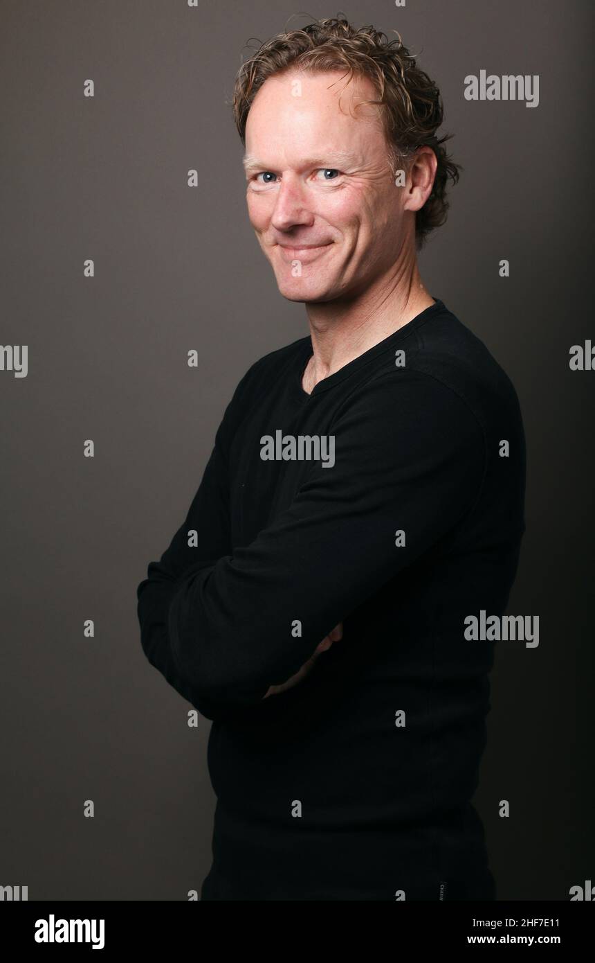 Portrait of a beautiful happy man in front of a colored background ...