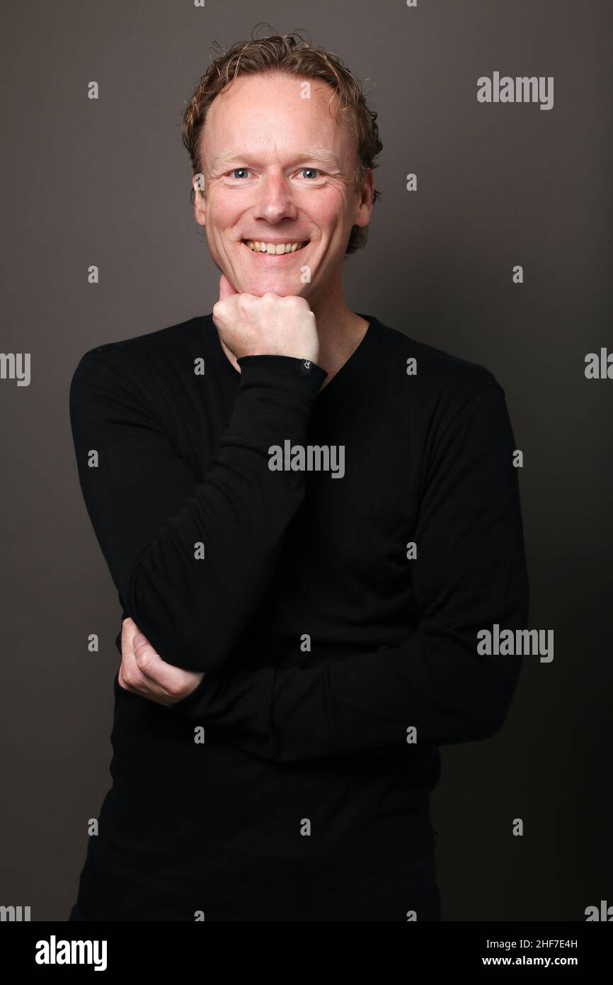 Portrait of a beautiful happy man in front of a colored background ...