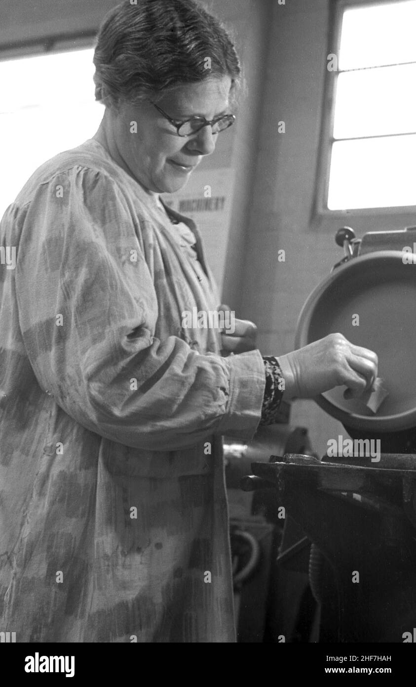 1940s, historical, lady at a wood-working class, sandying a wooden bowl ...