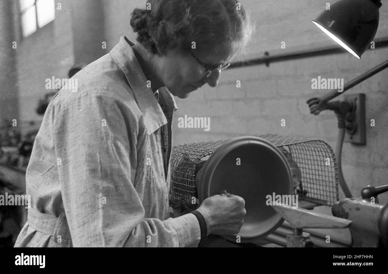 1940s, historical, a mature lady at a wood-working class, sandying a ...