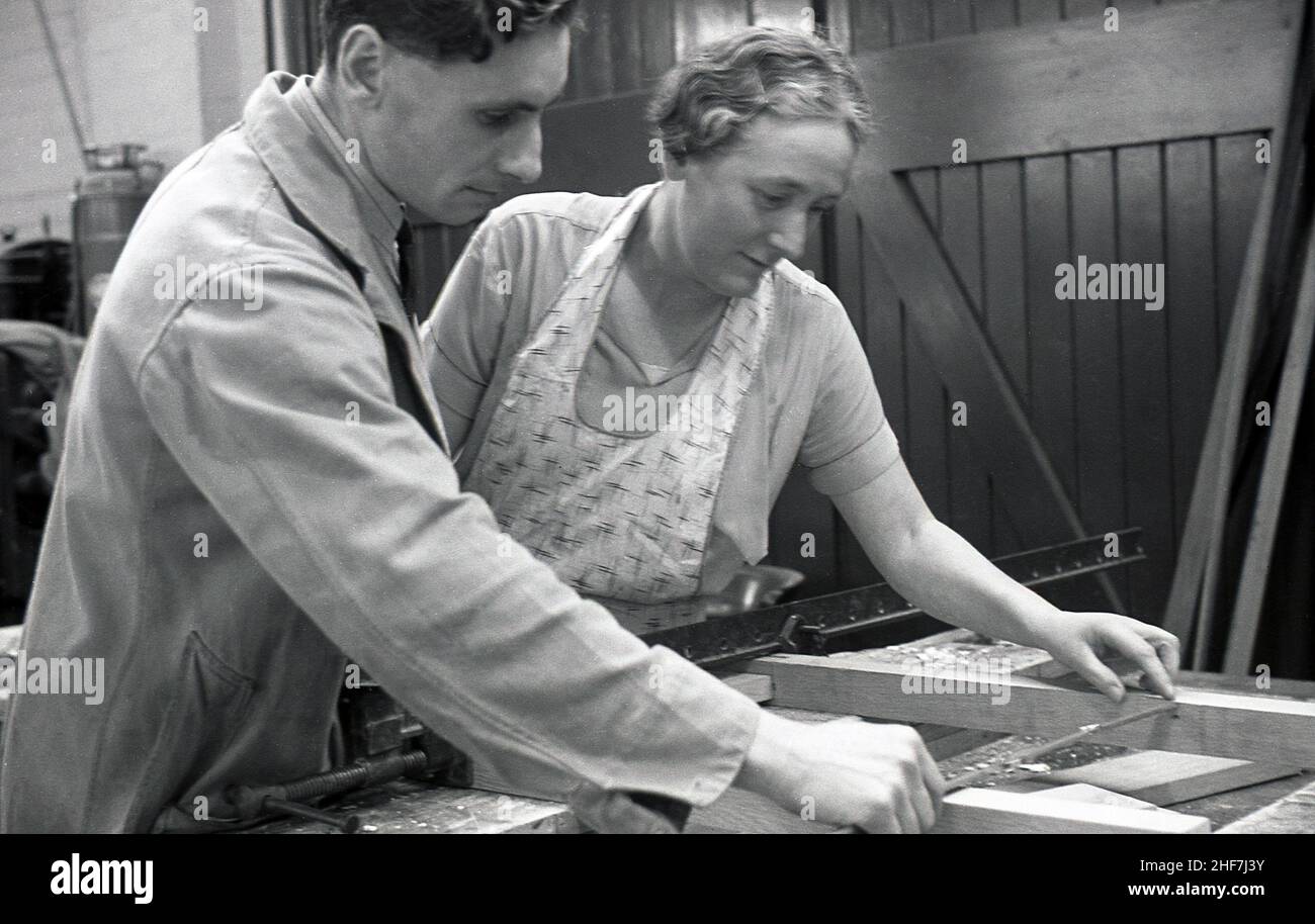1940s, historical, lady wearing an apron at a wood-working class, with ...