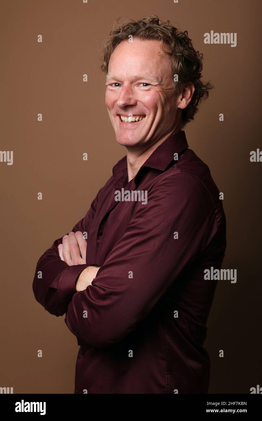 Portrait of a beautiful happy man in front of a colored background ...