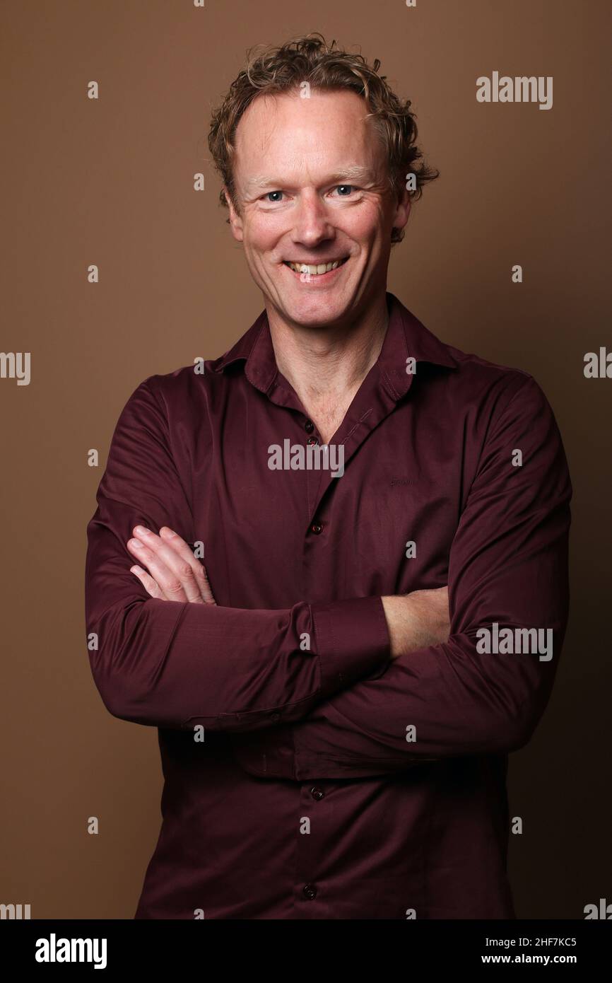 Portrait of a beautiful happy man in front of a colored background ...