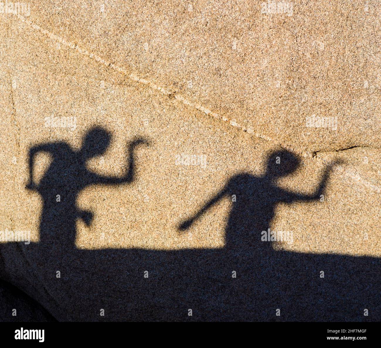 children playing with shadows on a rock in Jushua Tree National park ...