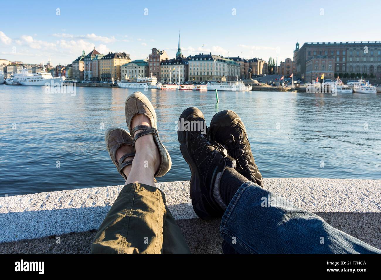 Sweden, Stockholm, view of the old town, quay, jetty, feet up, symbolic ...