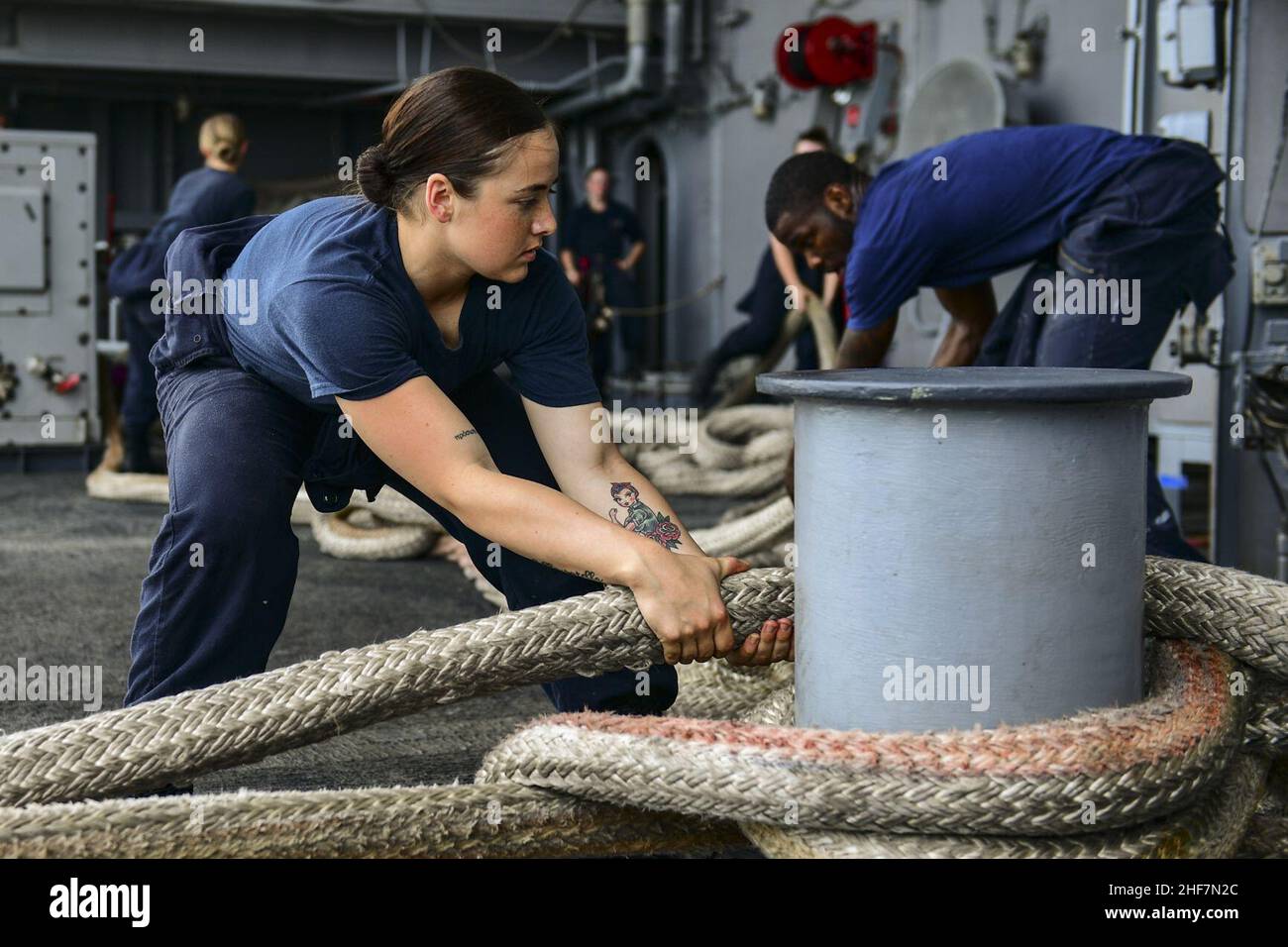 Seaman handles mooring line on the fantail of USS Theodore Roosevelt ...