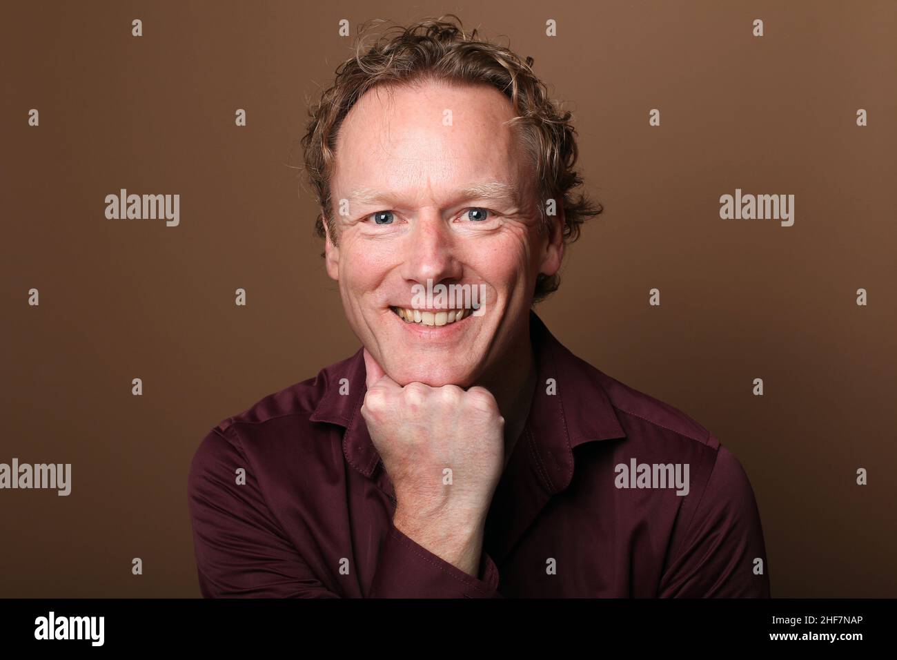 Portrait of a beautiful happy man in front of a colored background ...