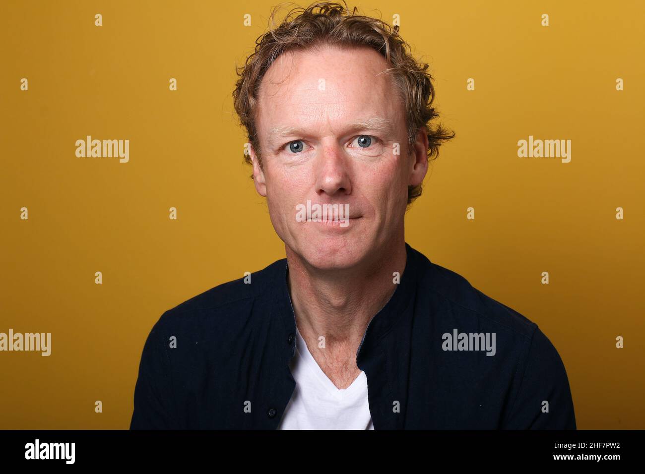 Portrait of a beautiful happy man in front of a colored background ...