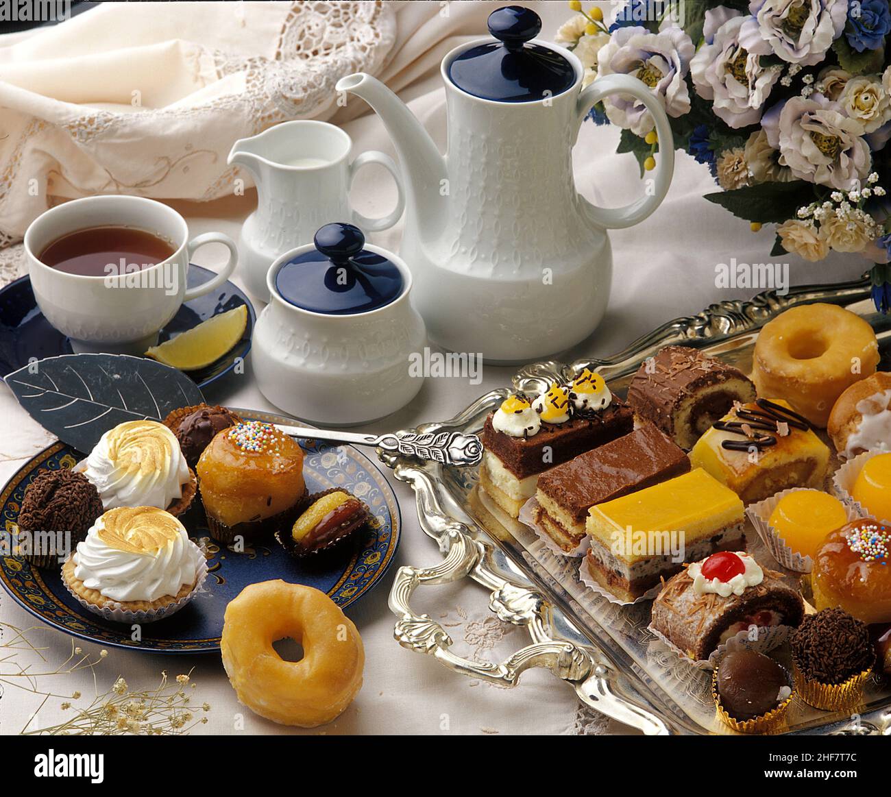 Trays with assortment of sweets and tea service Stock Photo - Alamy