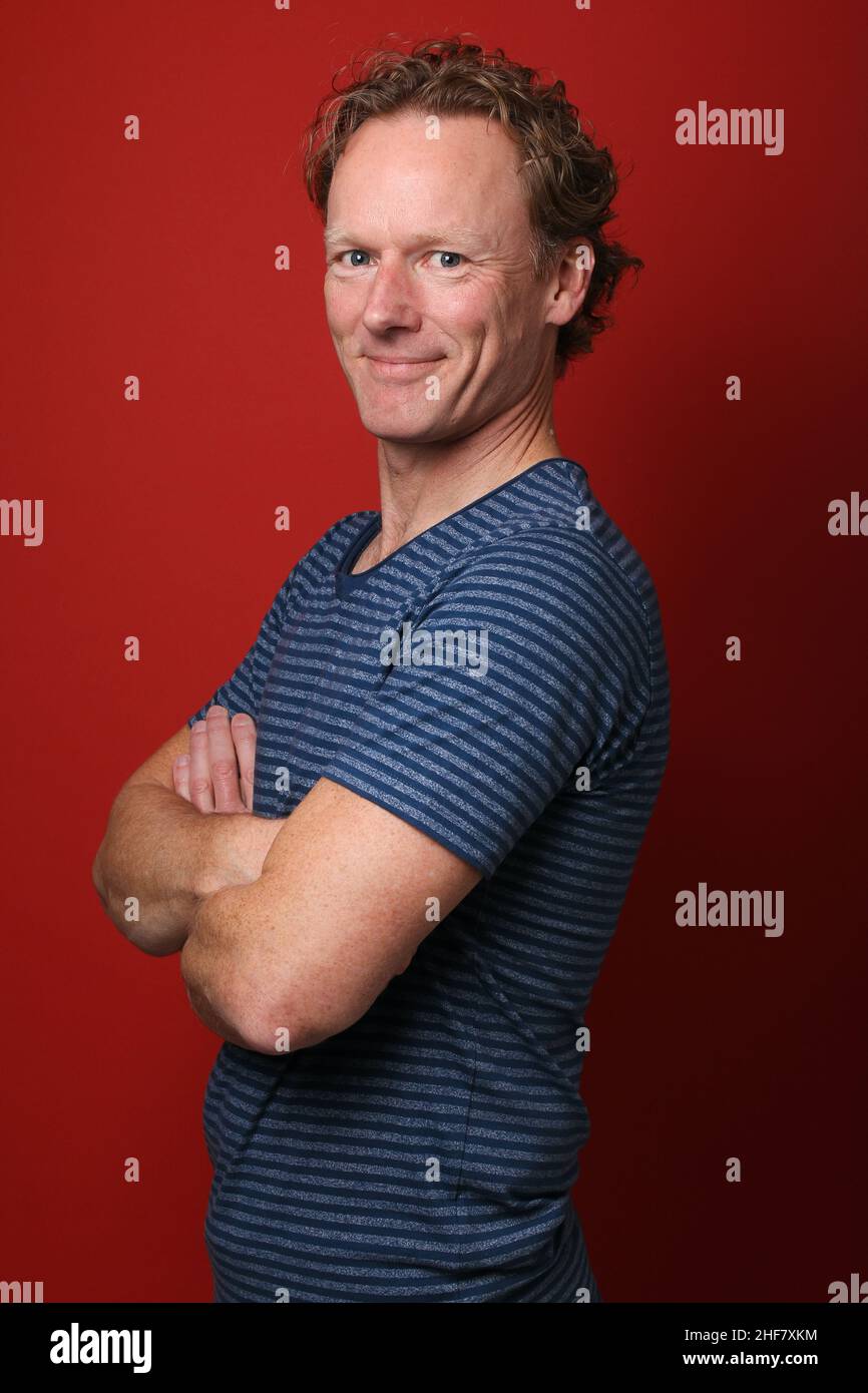 Portrait of a beautiful happy man in front of a colored background ...