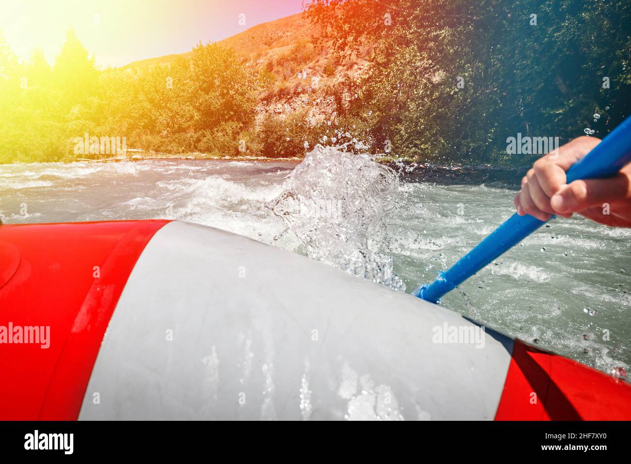 Rafting on a mountain river. Close-up of raft boat side with oar in ...