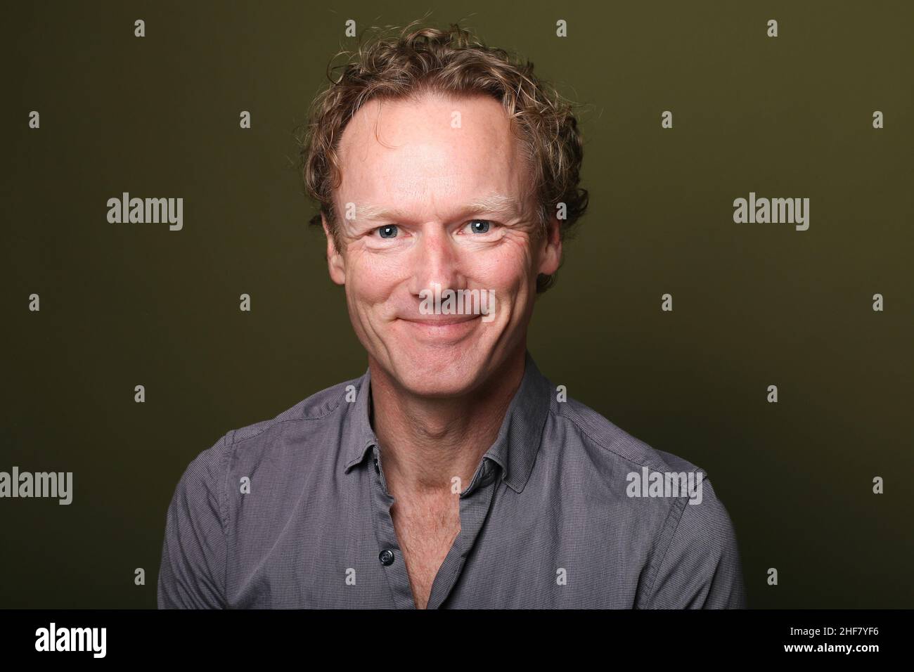 Portrait of a beautiful happy man in front of a colored background ...
