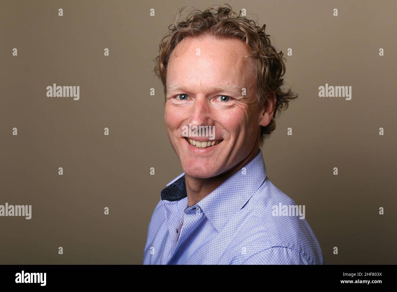 Portrait of a beautiful happy man in front of a colored background ...