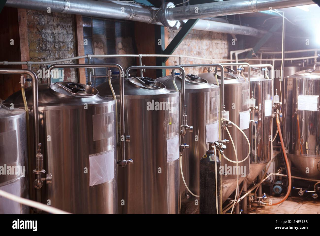 Row of many steel beer tanks at microbrewery Stock Photo - Alamy