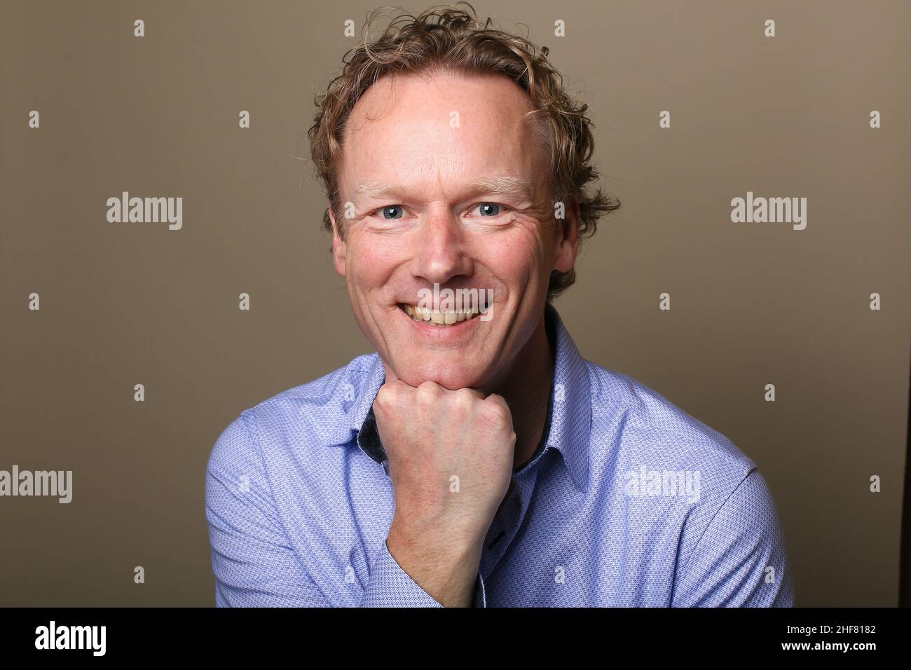 Portrait of a beautiful happy man in front of a colored background ...