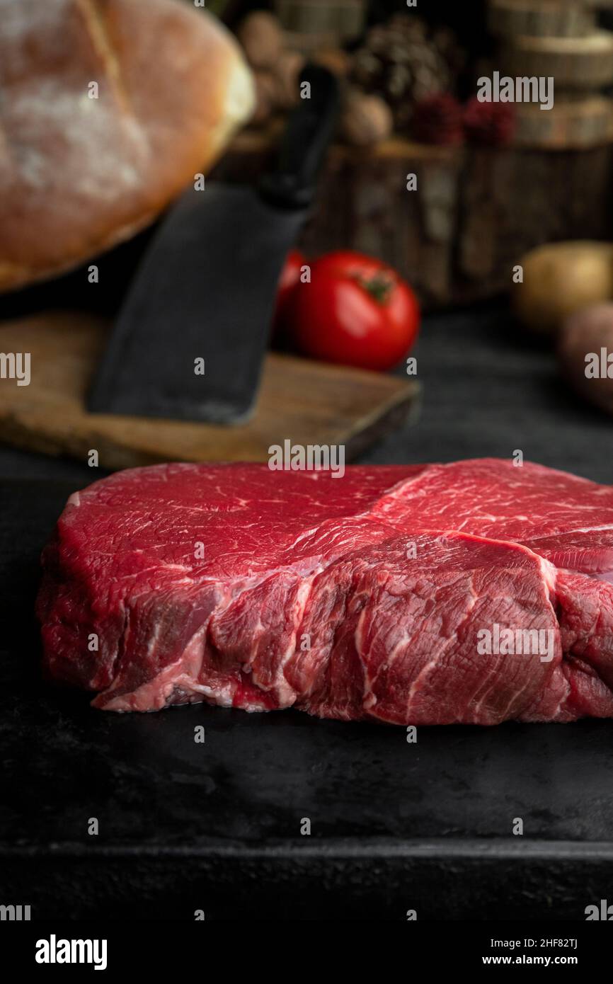 Raw beef steak in the kitchen. Butchering and cooking concept Stock ...