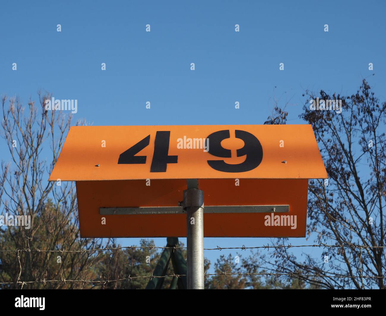 Stencil number 49 sign in black over orange Stock Photo - Alamy