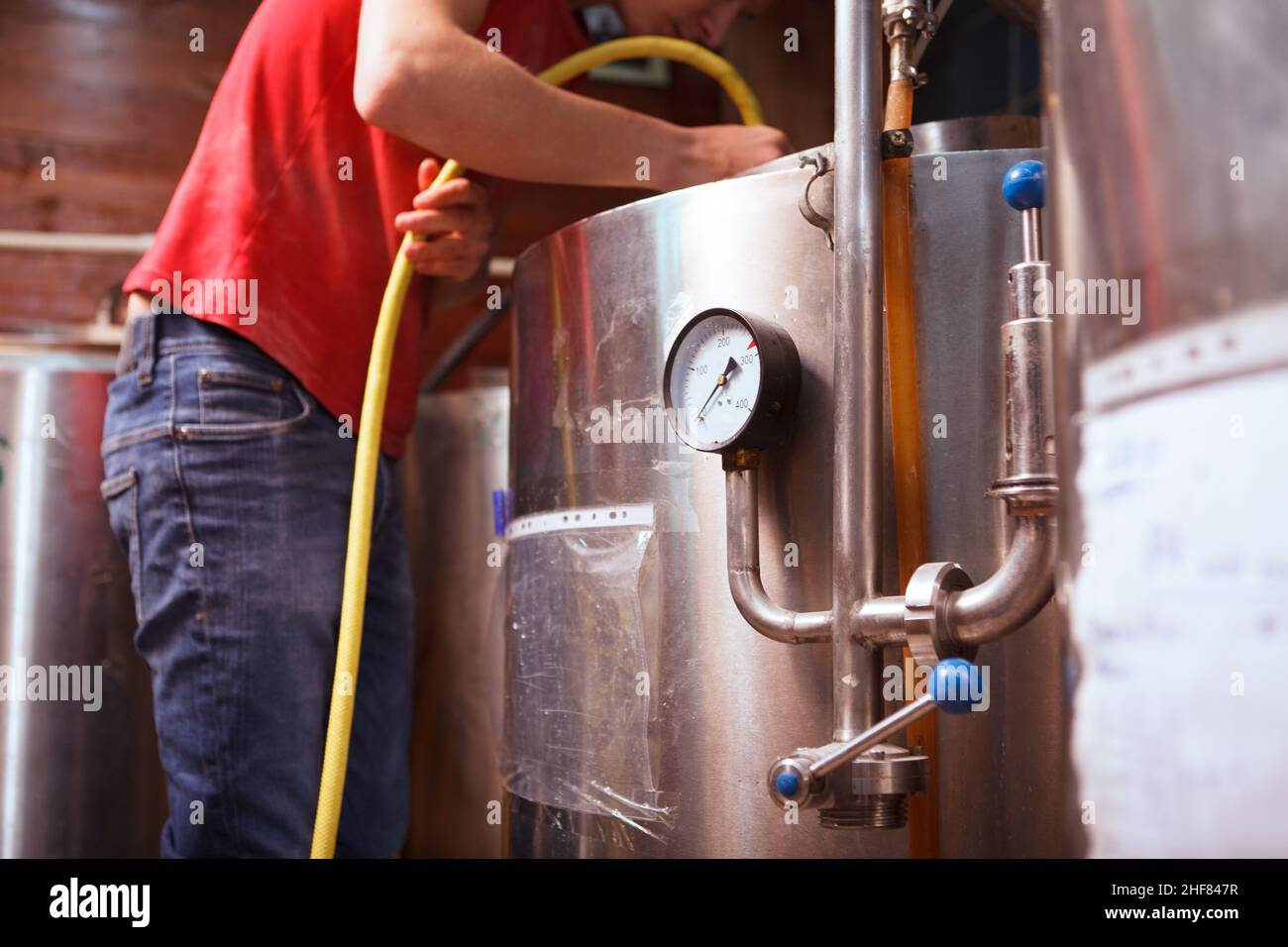 Selective focus on pressure gauge of beer tank, brewery technician ...