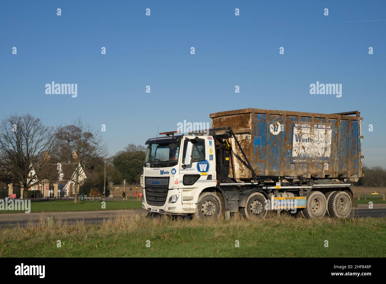 Waste removal truck carries a container en route to recycling centre ...