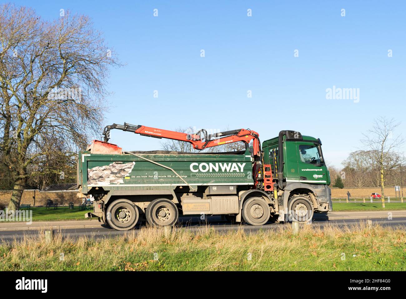 Green Conway waste management truck with on board crane Stock Photo - Alamy