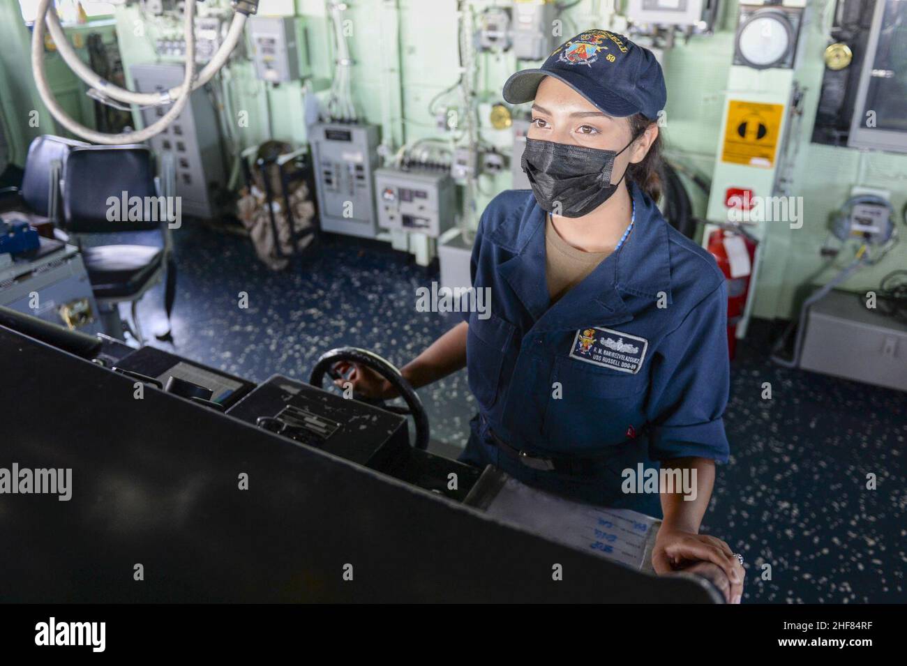 Seaman Rose Ramirez, from San Diego, mans the helm in the pilot house ...