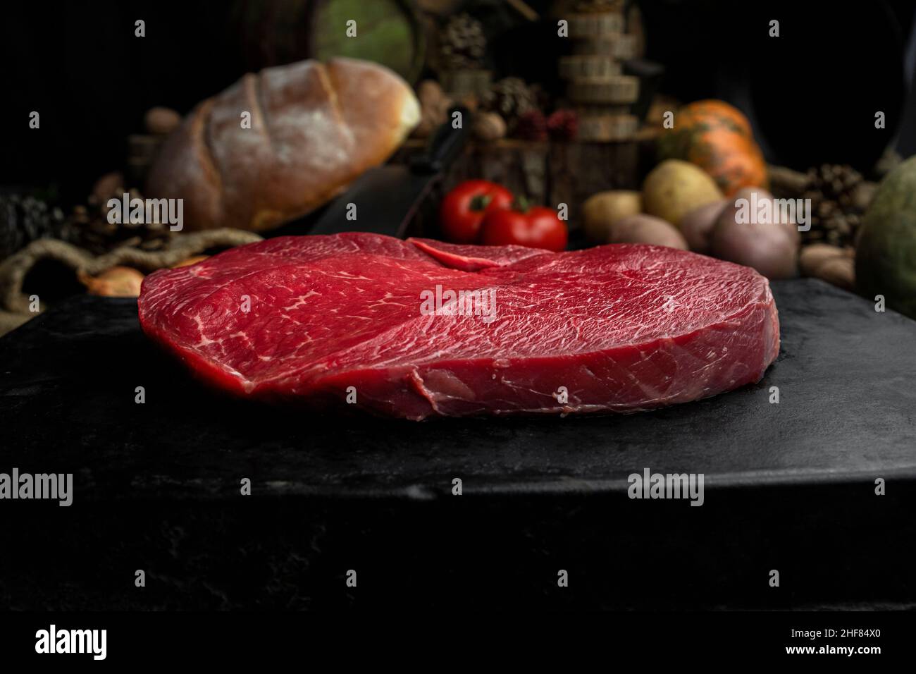 Raw beef steak in the kitchen. Butchering and cooking concept Stock ...
