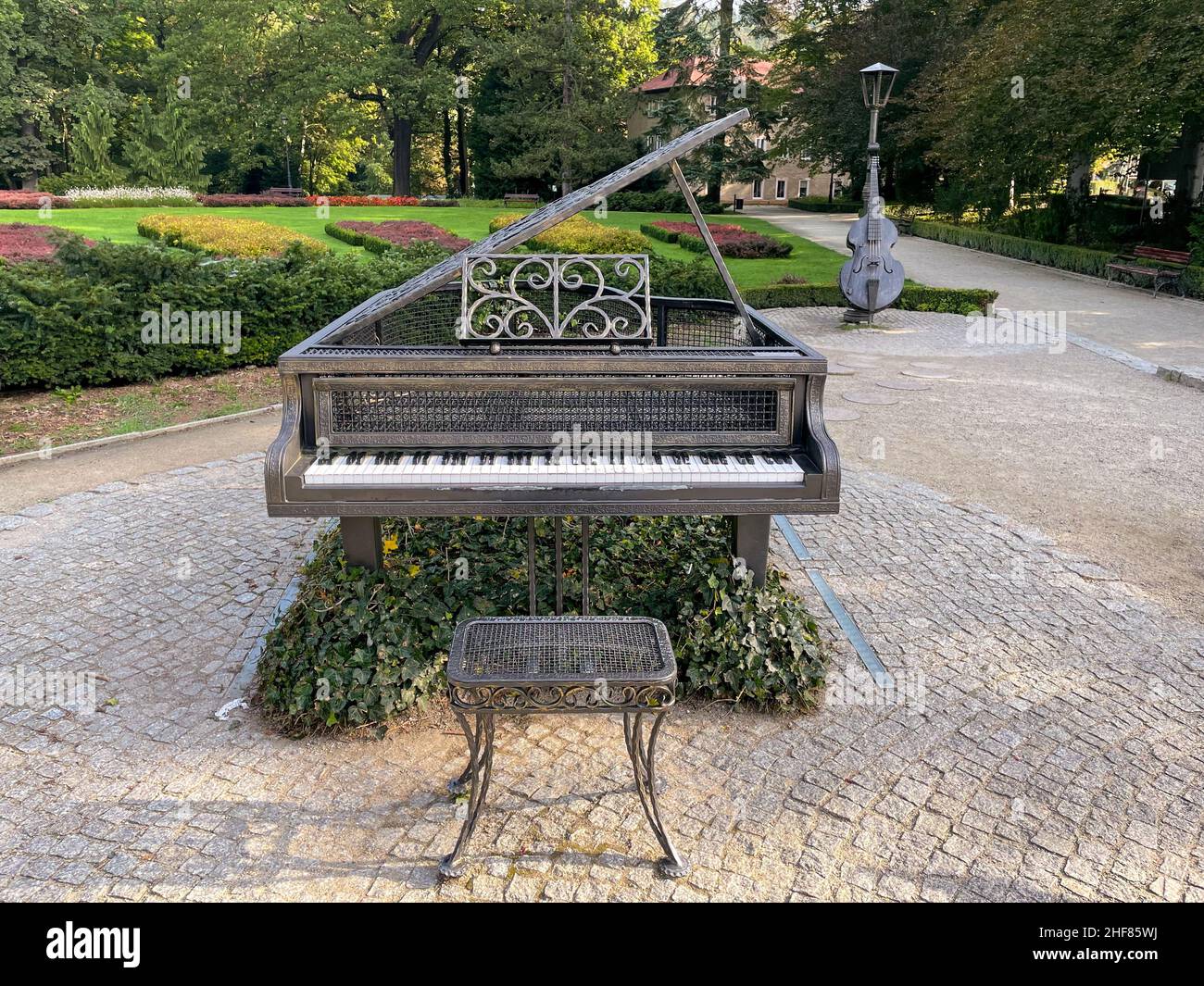 Statue of a piano with stool in a park in the Polish spa town of Kudowa ...