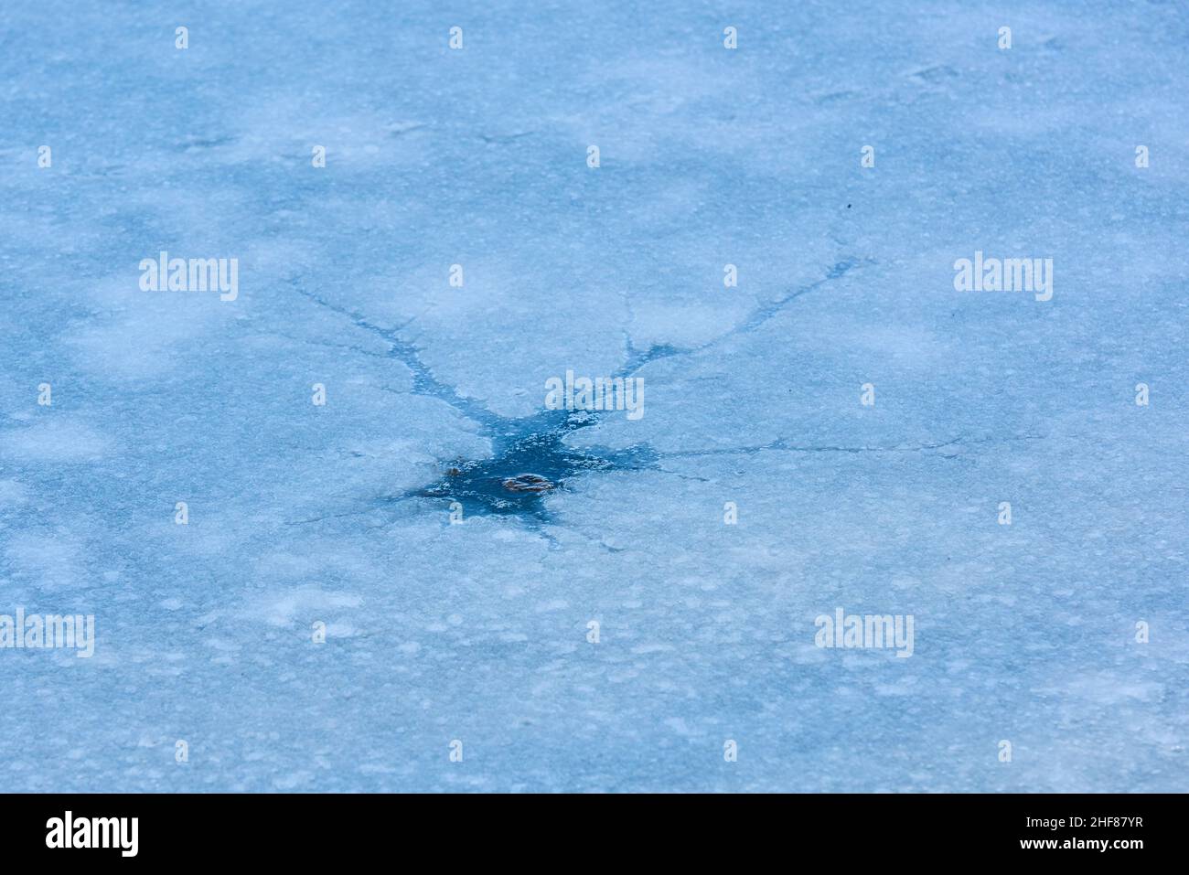 Hole and cracks in an ice on a lake hi-res stock photography and images ...