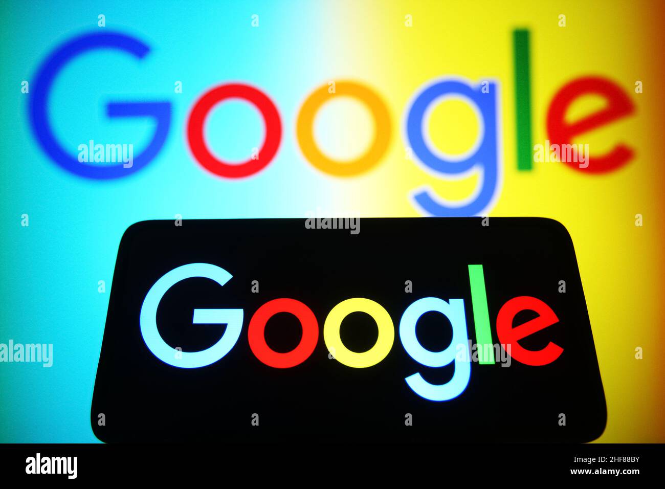 In this photo illustration, a Google logo is seen on a smartphone and a ...