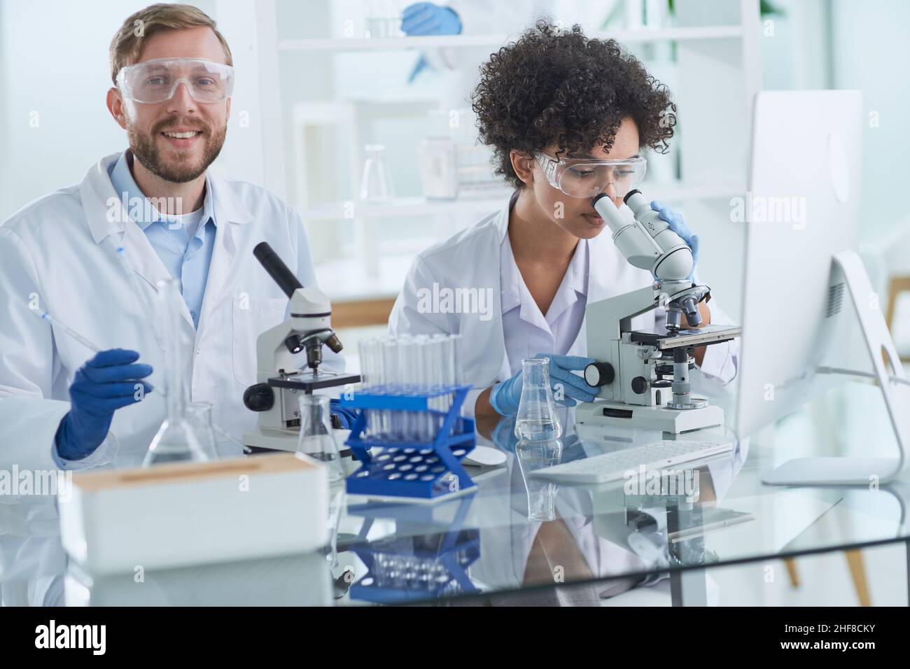 Smiling scientists looking at camera arms crossed in laboratory Stock ...