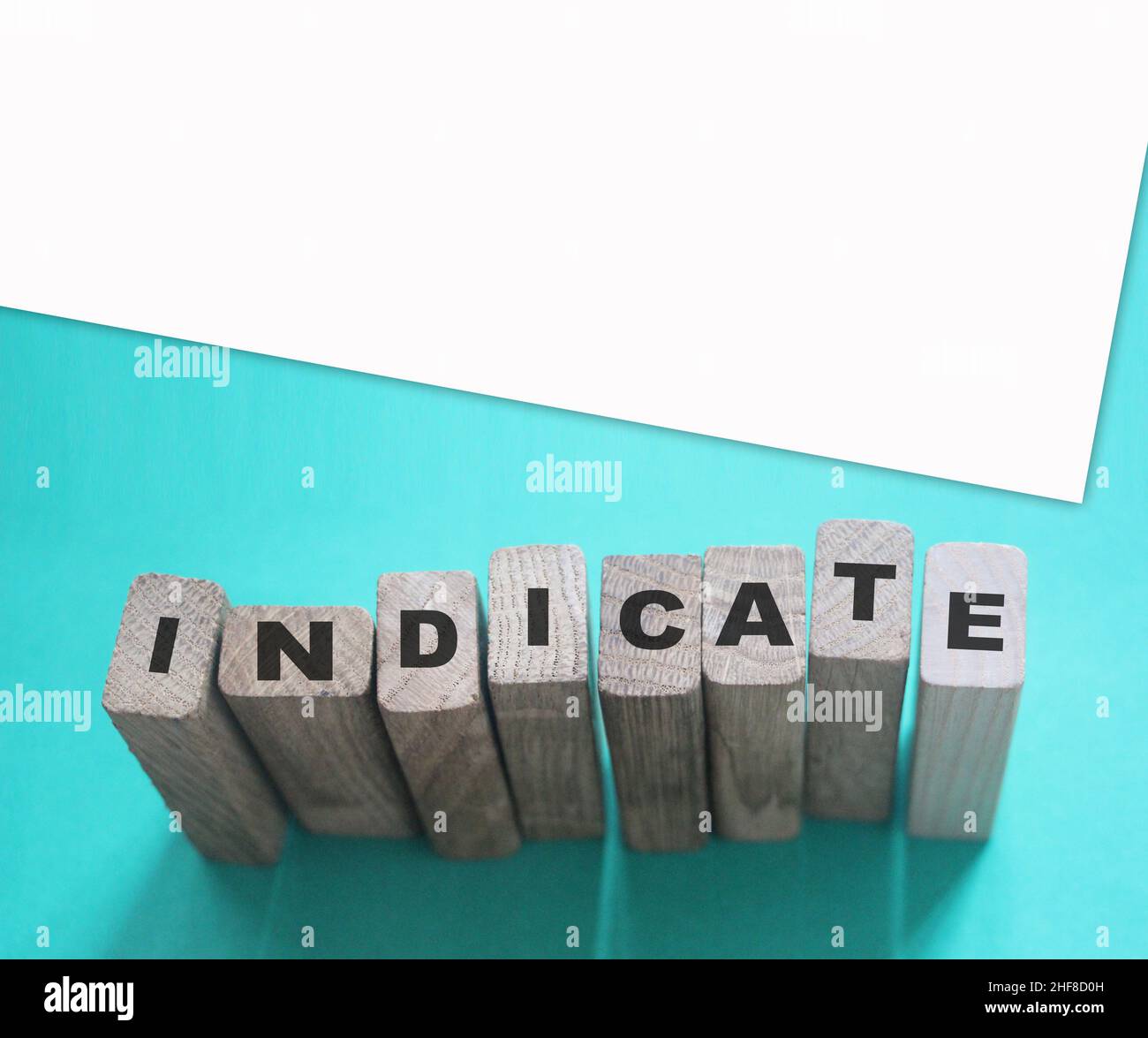 Indicate word on wooden blocks on cyan background. Financial indicator ...