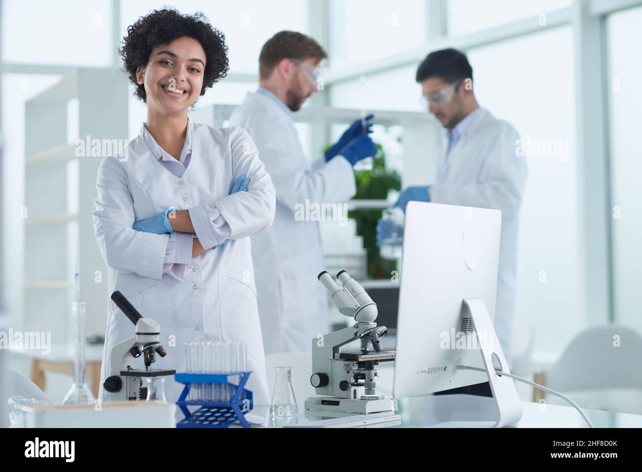 Smiling scientists looking at camera arms crossed in laboratory Stock ...