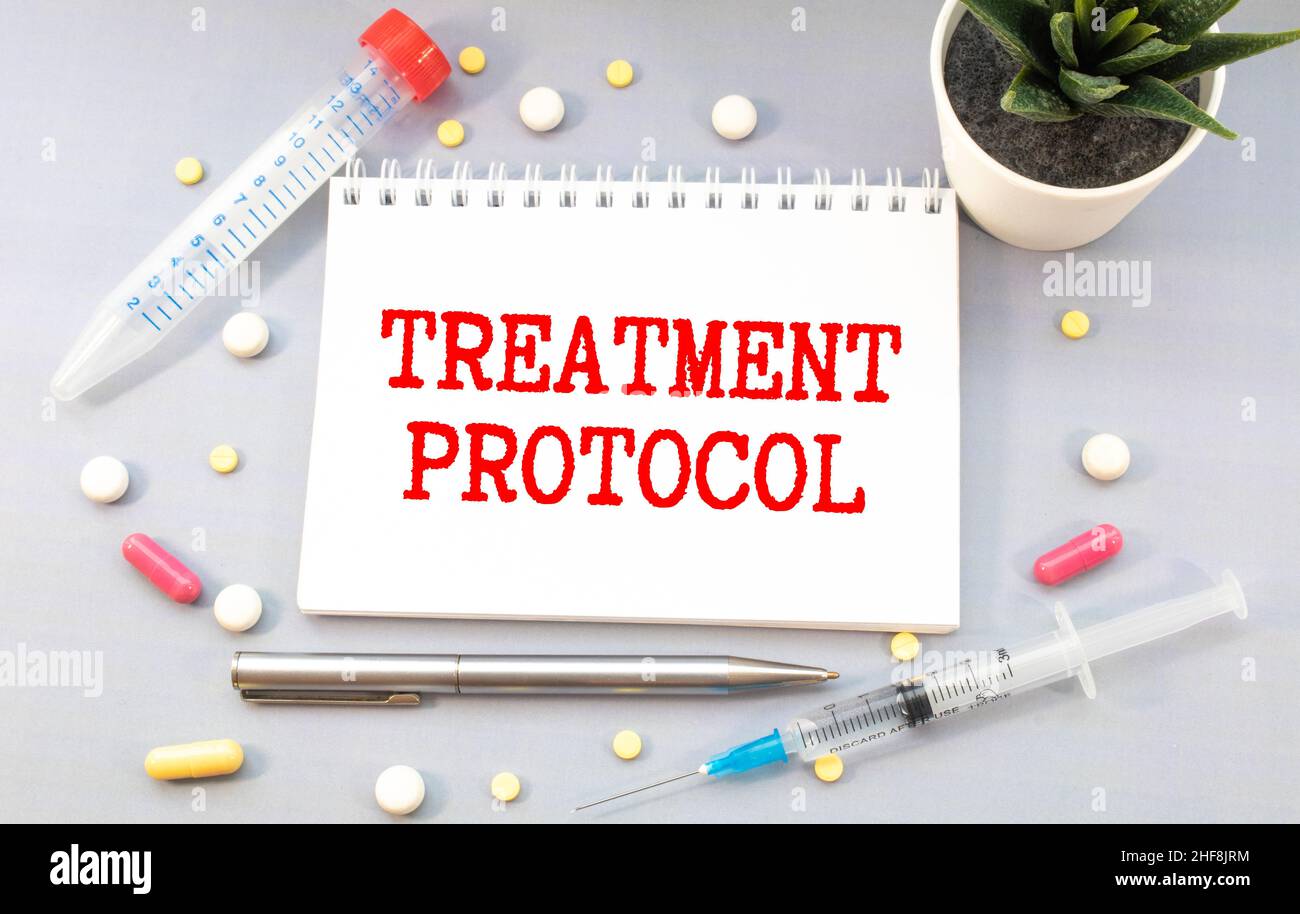 The words treatment protocol is written on white paper on a grey ...