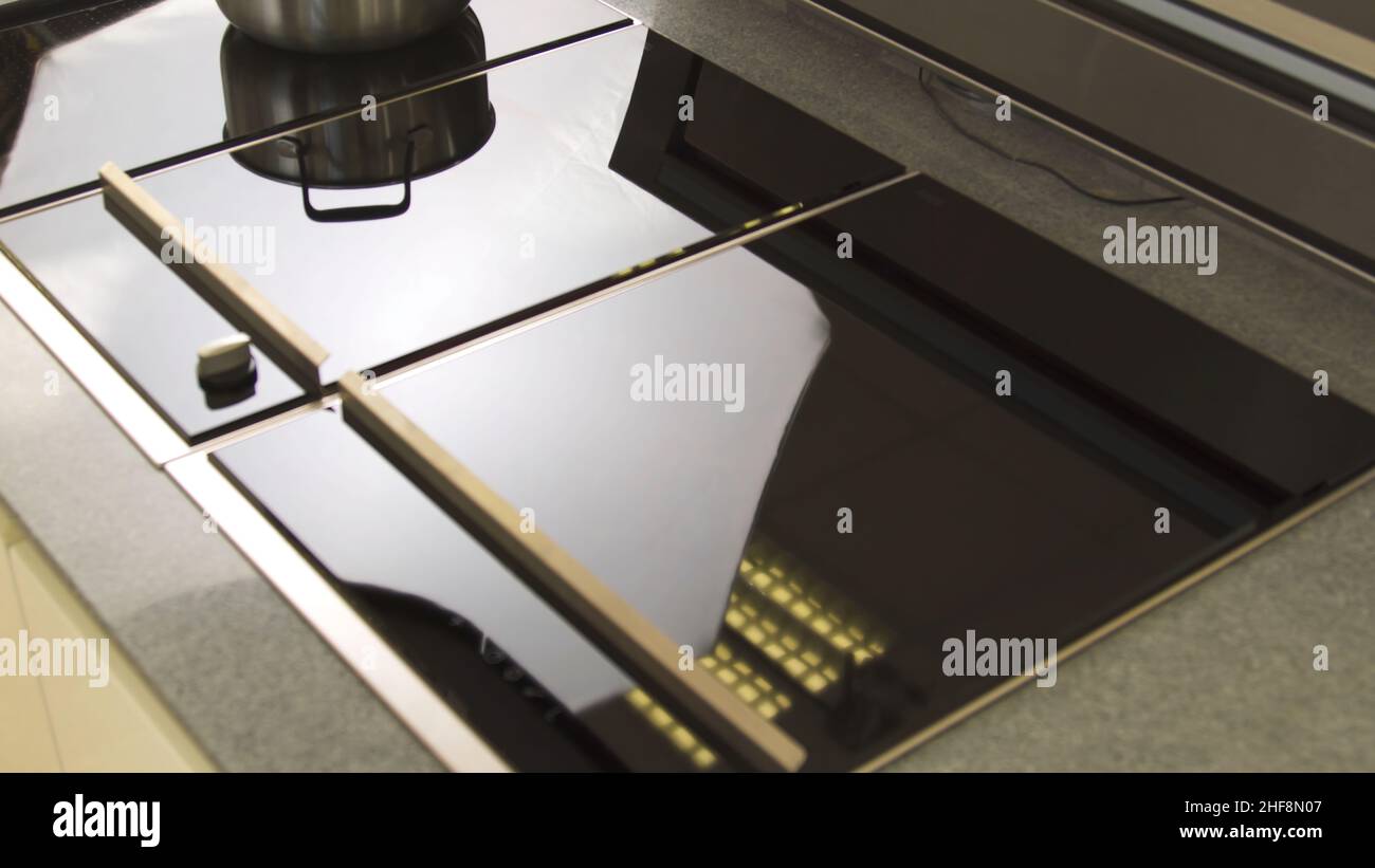 Close up of functional kitchen induction hob in a new flat. Details of ...