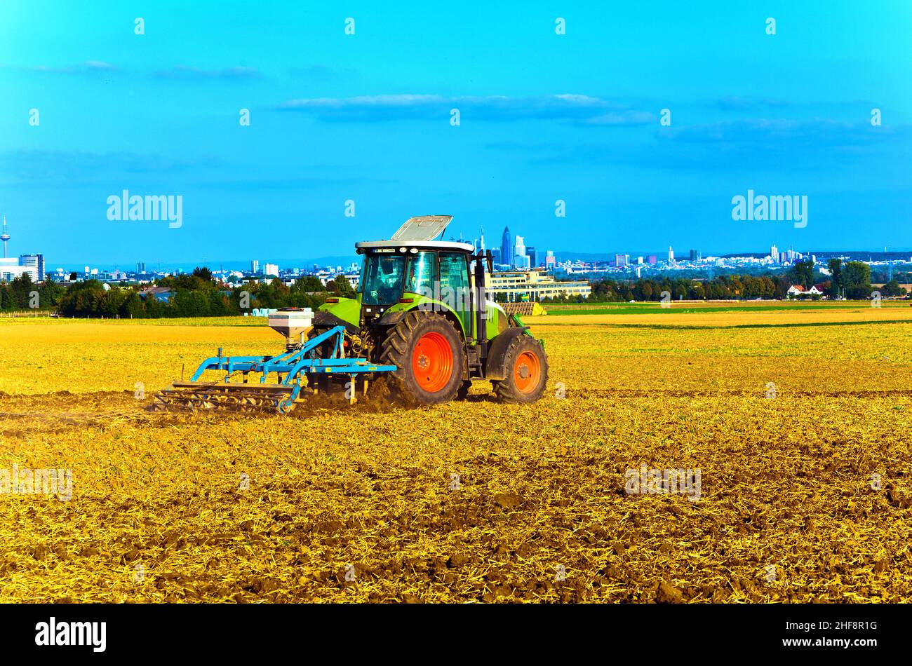 Small scale farming with tractor and plow in field Stock Photo - Alamy