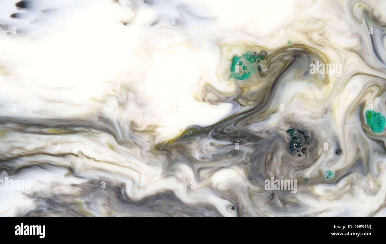 Colorful paints, loquid soapdrops mixing in white substance. Beautiful ...