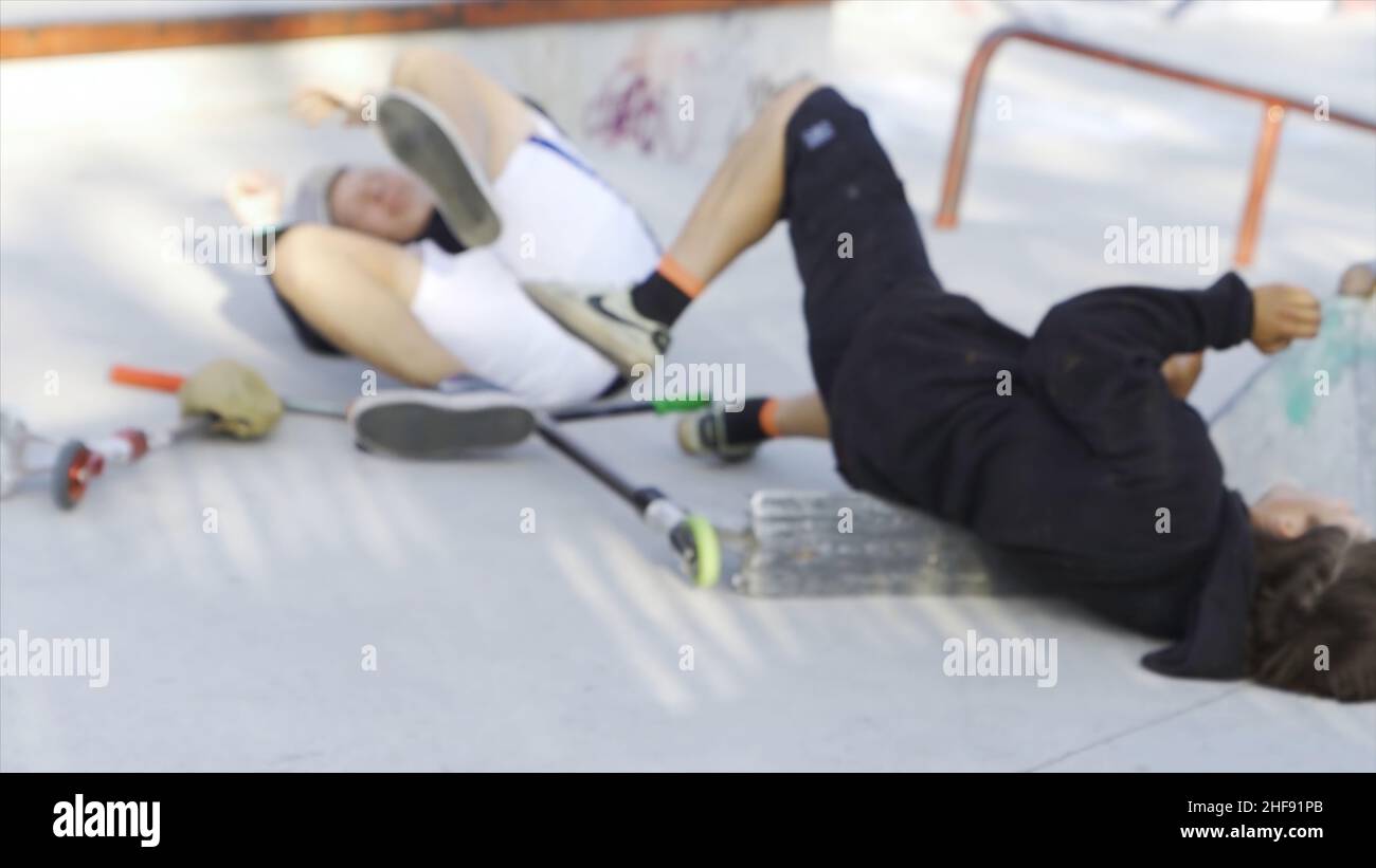 Teenagers did unsuccessful trick on sportive push scooter on a city ...