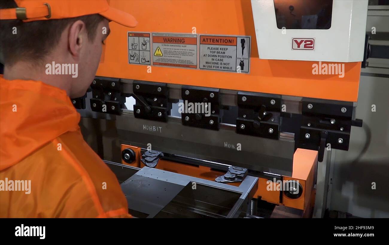 Operator bending metal sheet by sheet bending machine, high precision ...