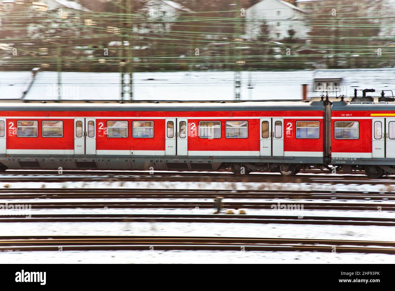 train in motion passes houses in winter and snowy white rails Stock ...