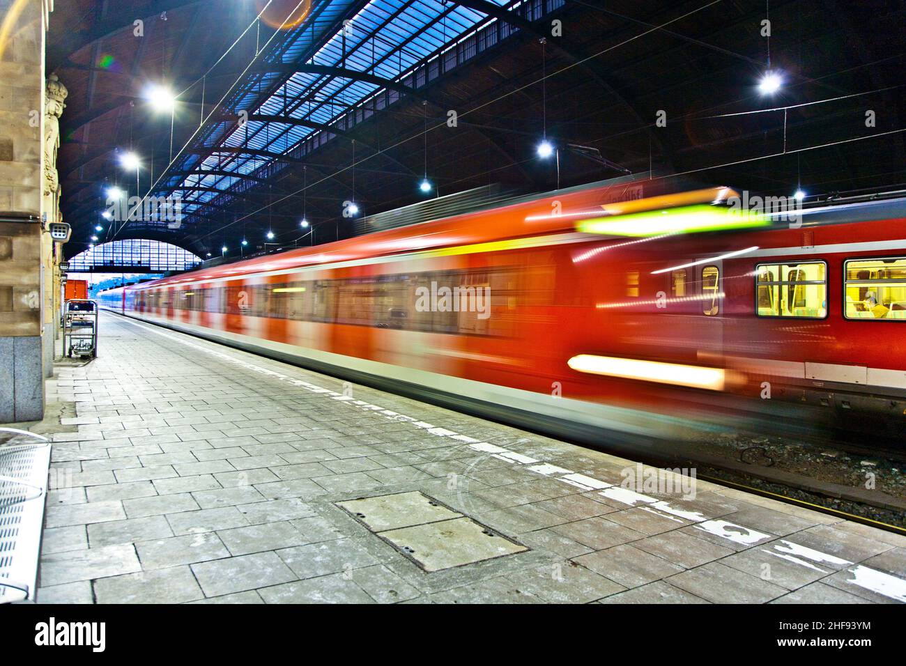 Train im motion enters the station Stock Photo - Alamy