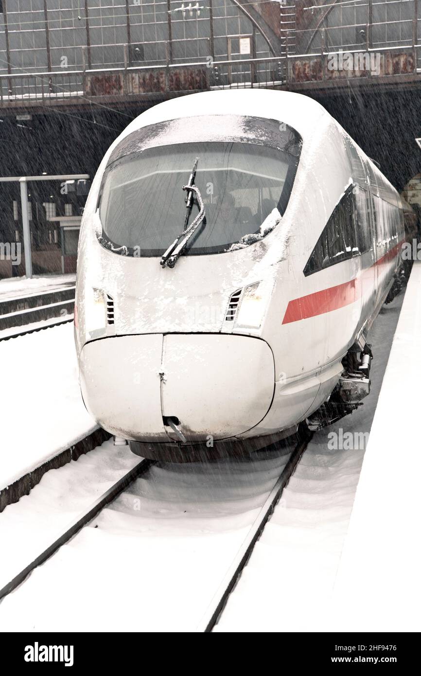 high speed train in station with snow covered rails Stock Photo - Alamy