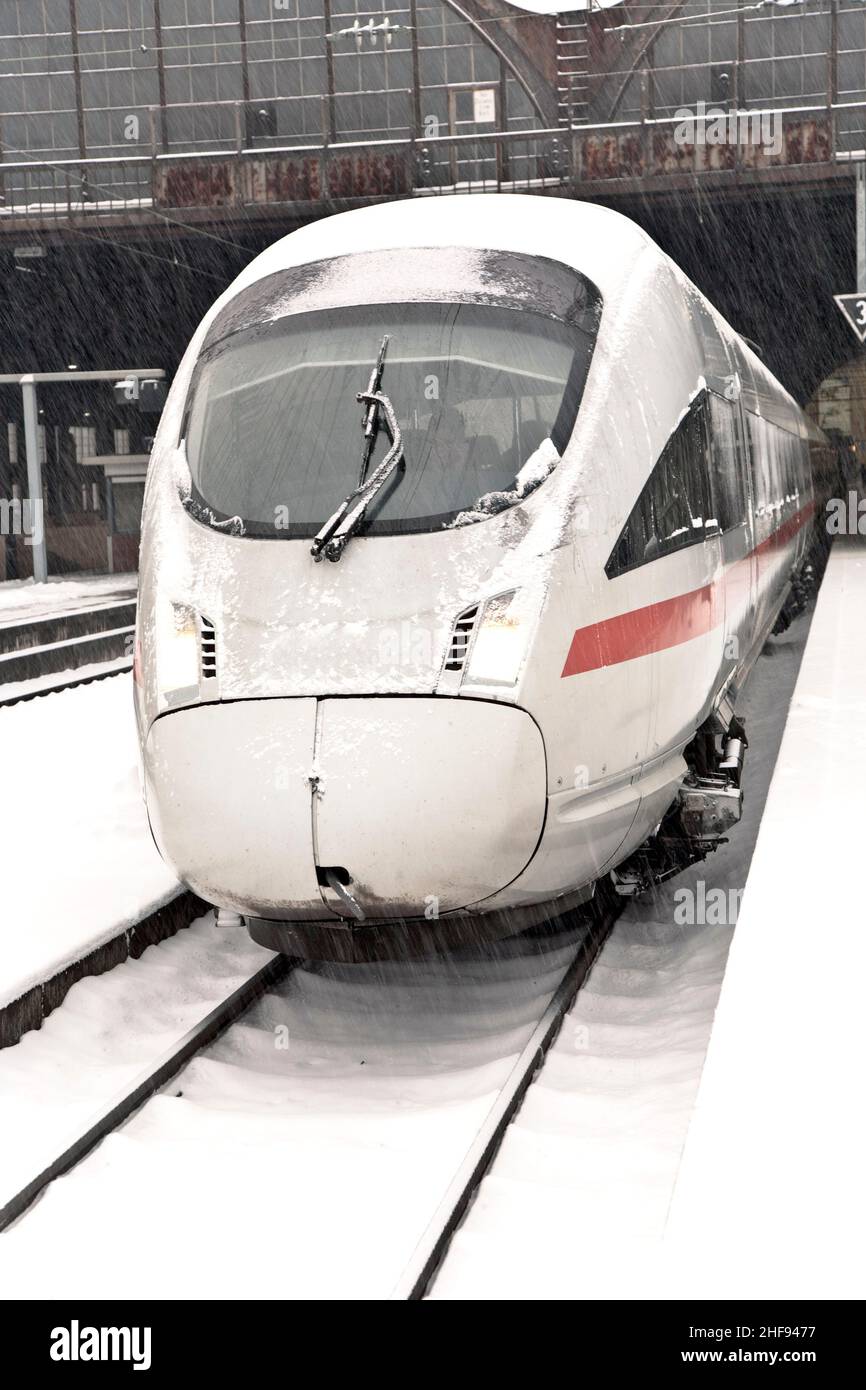high speed train in station with snow covered rails Stock Photo - Alamy