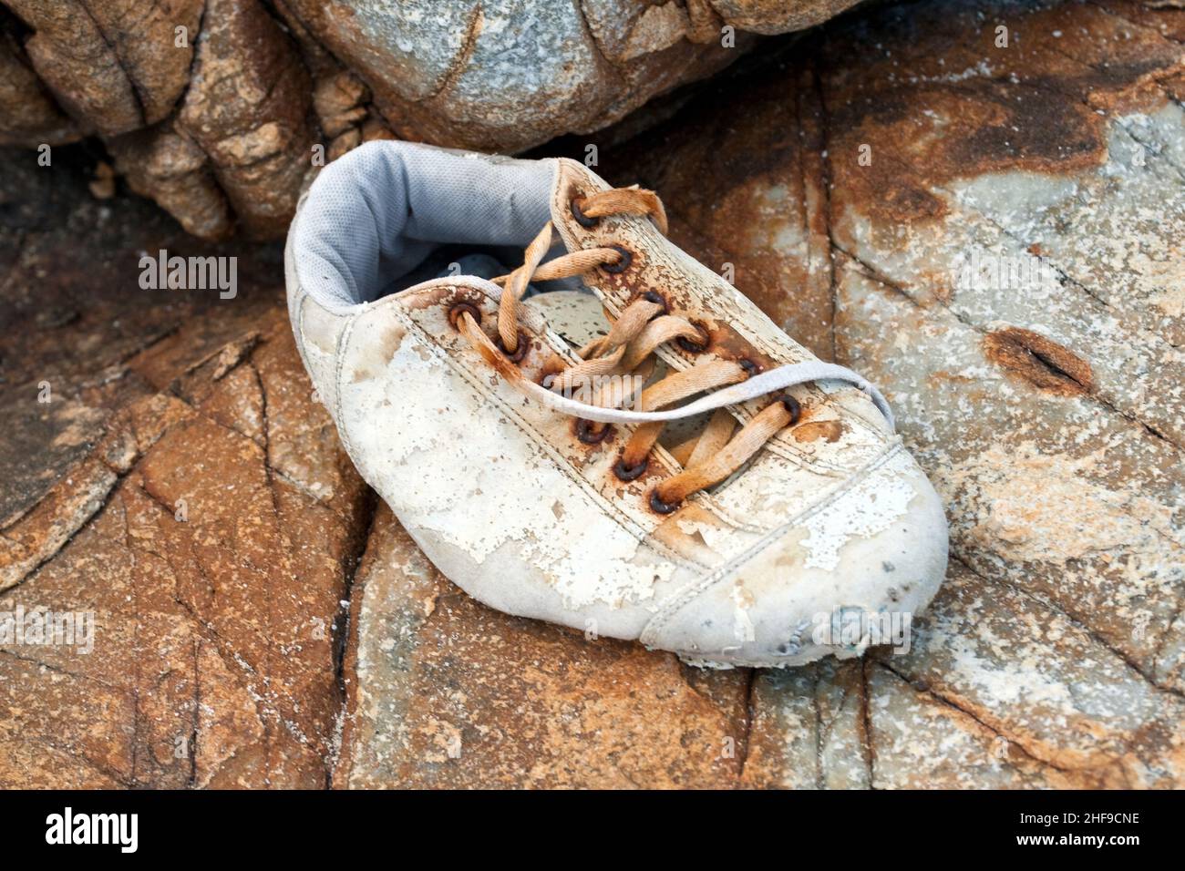rotten shoes on beautiful rock Stock Photo - Alamy